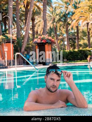 Pool with lounge chairs in resort hotel with mountain view Stock Photo ...