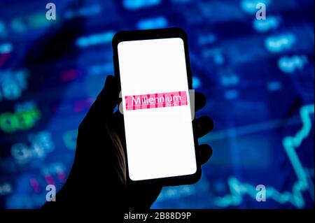 In this photo illustration a Millenium Bank logo seen displayed on a ...