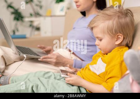 Concentrated kid using laptop in wigwam with luminous bulbs Stock Photo ...