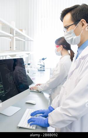 Two chemists working in lab experimenting Stock Photo - Alamy