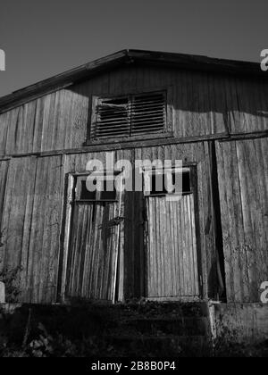 Greyscale of an old wooden barn under the sunlight at daytime Stock ...