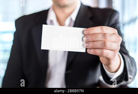 Businessman in suit hold empty card and stopwatch. Blue background ...