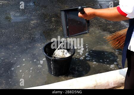 people are sweeping dirty water at ground streets, cleaner floor ...