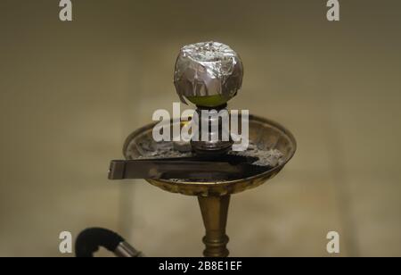 Bowl and head of Syrian hookah made of green apple, with foil on it ...