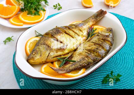 Just baked freshwater bream fish cooked with fresh rosemary and species ...