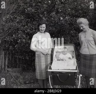 1950s, historical, a proud mother standing beside her young daughter ...