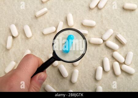 Zooming pills using magnifier glass. Special unique pills isolated on ...