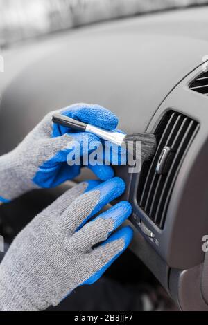 Cleaning ventilation in car with brush and cleaning car Stock Photo - Alamy