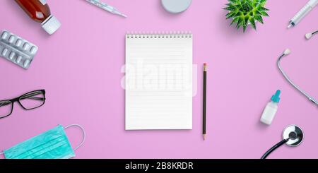 Empty notepad on hospital desk surrounded by medical equipment. Top ...