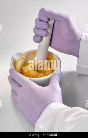 Scientist using pestle and mortar Stock Photo - Alamy