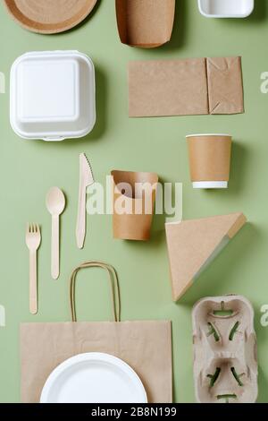 White craft plate, cutlery and green plants at black table Stock Photo ...