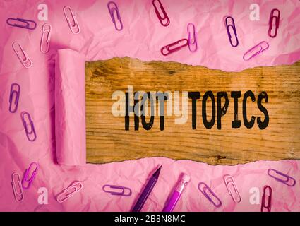 Writing note showing Hot Topics. Business concept for subject that a ...