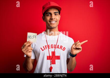 Young handsome african american lifeguard man wearing t-shirt with red ...