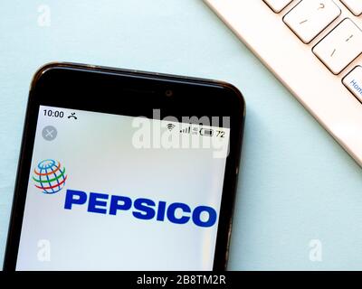 In this photo illustration a Pepsico logo seen displayed on a ...