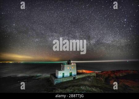 The Milky Way over Bamburgh Lighthouse in Northumberland Stock Photo ...
