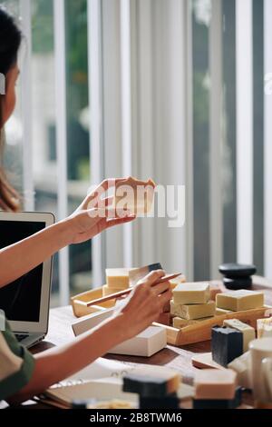 Fragrant striped handmade soap in a wicker basket on a white napkin ...