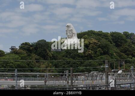 Japan, Kanagawa, Kamakura, Ofuna Kannon and Ofuna Station at dawn ...