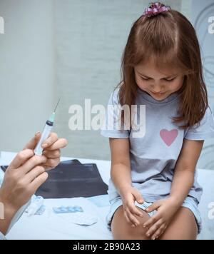 girl is crying afraid of the injection vaccination. Fear of injections ...