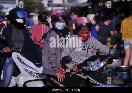 Indians wearing face masks as a precaution against the coronavirus walk ...