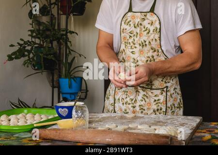 Kid hands cooking dumplings with raw salmon on the kitchen. Stay at ...