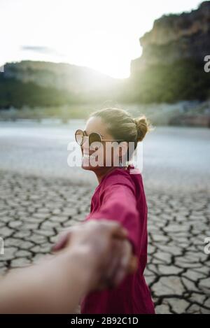 Feeling relaxed. Smiling young woman with her hands on either side of ...