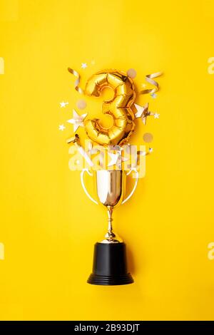 Gold foil number 3 three celebration balloon Stock Photo - Alamy