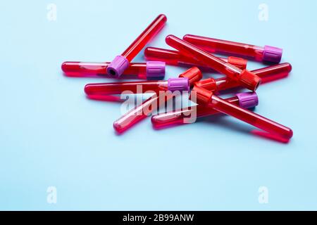 Blood in test tubes on blue background. Copy space Stock Photo - Alamy