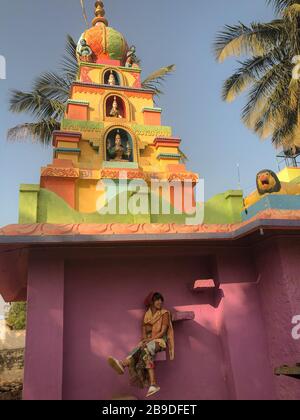 ancient hindu temple architecture with girl witnessing it at evening ...