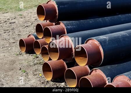 Metal pipes for water pipes folded on the grass Stock Photo - Alamy