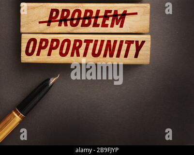Problem crossed out and opportunity on wooden blocks. Business startup ...