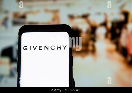In this photo illustration a Givenchy logo seen displayed on a ...