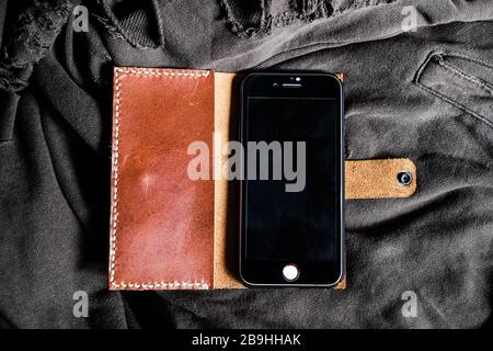 Genuine smartphone case with wallet handmade in paper box on vintage ...