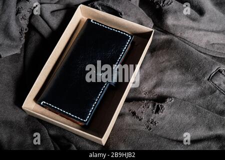 Genuine smartphone case with wallet handmade in paper box on vintage ...