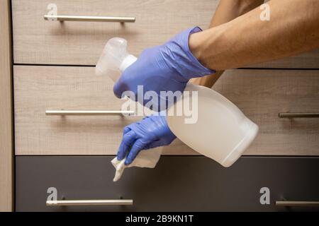 Disinfection and cleaning of cabinet handles. Prevention of coronavirus ...