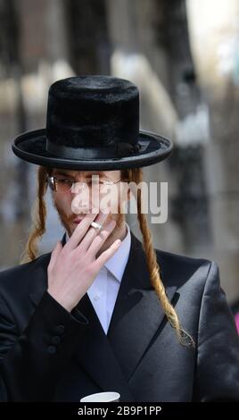 An Orthodox Jewish man smoking a cigarette Stock Photo - Alamy