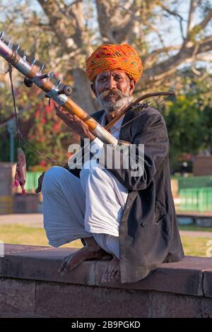 INDIA RAJASTHAN Mandore Garden. Musician playing a traditional ...