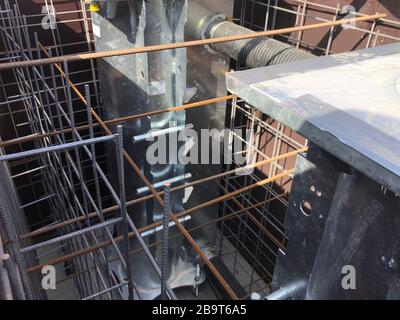 Pouring concrete to road bollard formwork foundation Stock Photo - Alamy