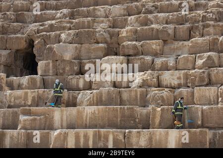 Giza, Egypt. 25th Mar, 2020. A worker takes part in a cleaning and ...