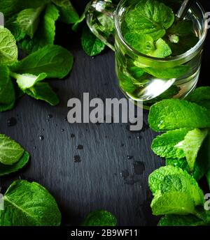 cup of black tea with mint leaves on a wooden table Stock Photo - Alamy