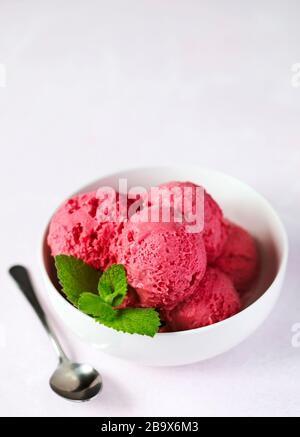 Raspberry ice cream in white bowl Stock Photo - Alamy