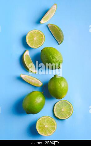 Fresh limes, on blue background Stock Photo - Alamy