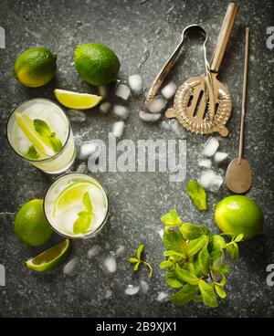 Cocktail making tools and glass on slate board. Bar tools: cocktail ...