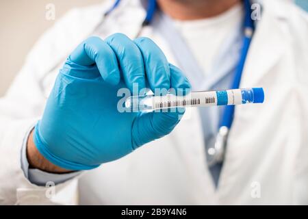 View of caucasian doctor with fictional test tube on a white background ...