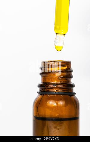 Bottle Cannabis oil hemp oil and pipette with fresh cannabis leaf on ...