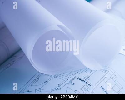 Rolls of building plans drawing designs Stock Photo - Alamy