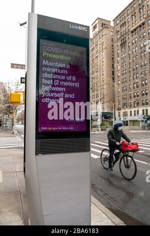 A delivery worker rides past a man scanning shared bicycles along a ...