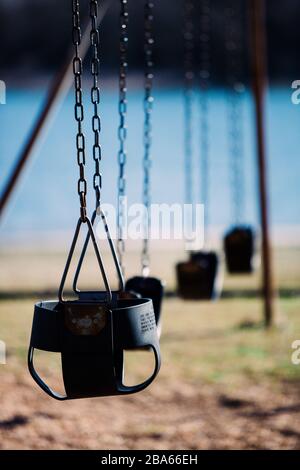 Swing set in park during snowy winter Stock Photo - Alamy