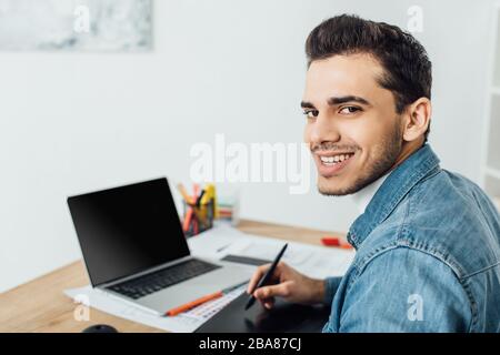 Ux developer and ui designer are using tablet and discussing ideas for ...