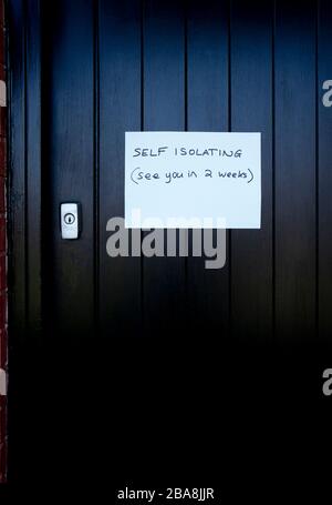 Handwritten self Isolation notice on black front door due to ...