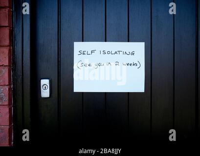 Handwritten self Isolation notice on black front door due to ...